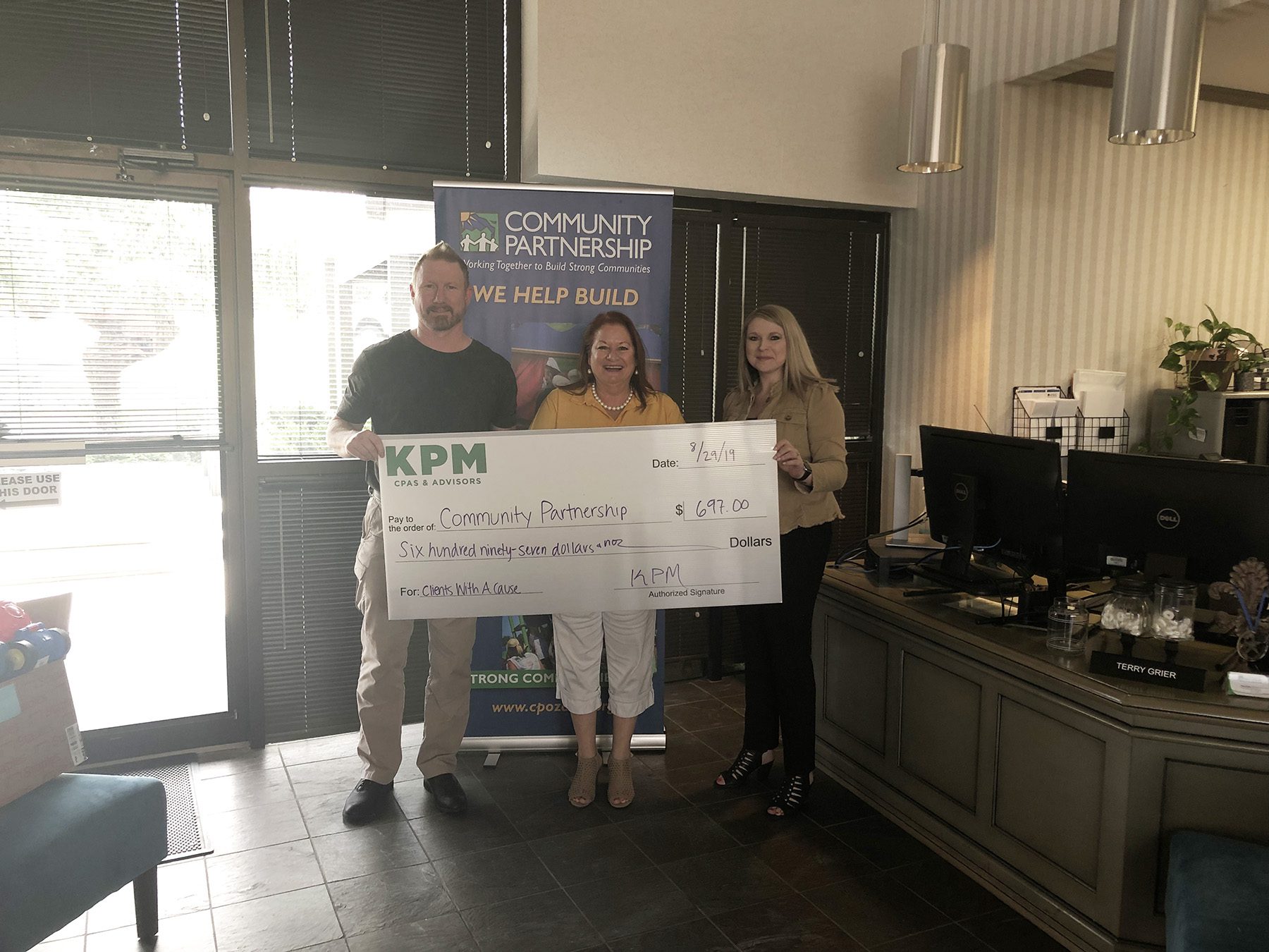 KPM Presents #ClientsWithACause Check to Community Partnership of the ...